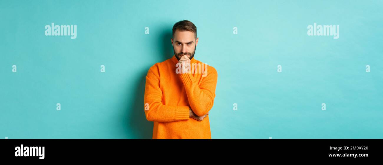 Thougtful young man making decision, looking serious and thinking ...