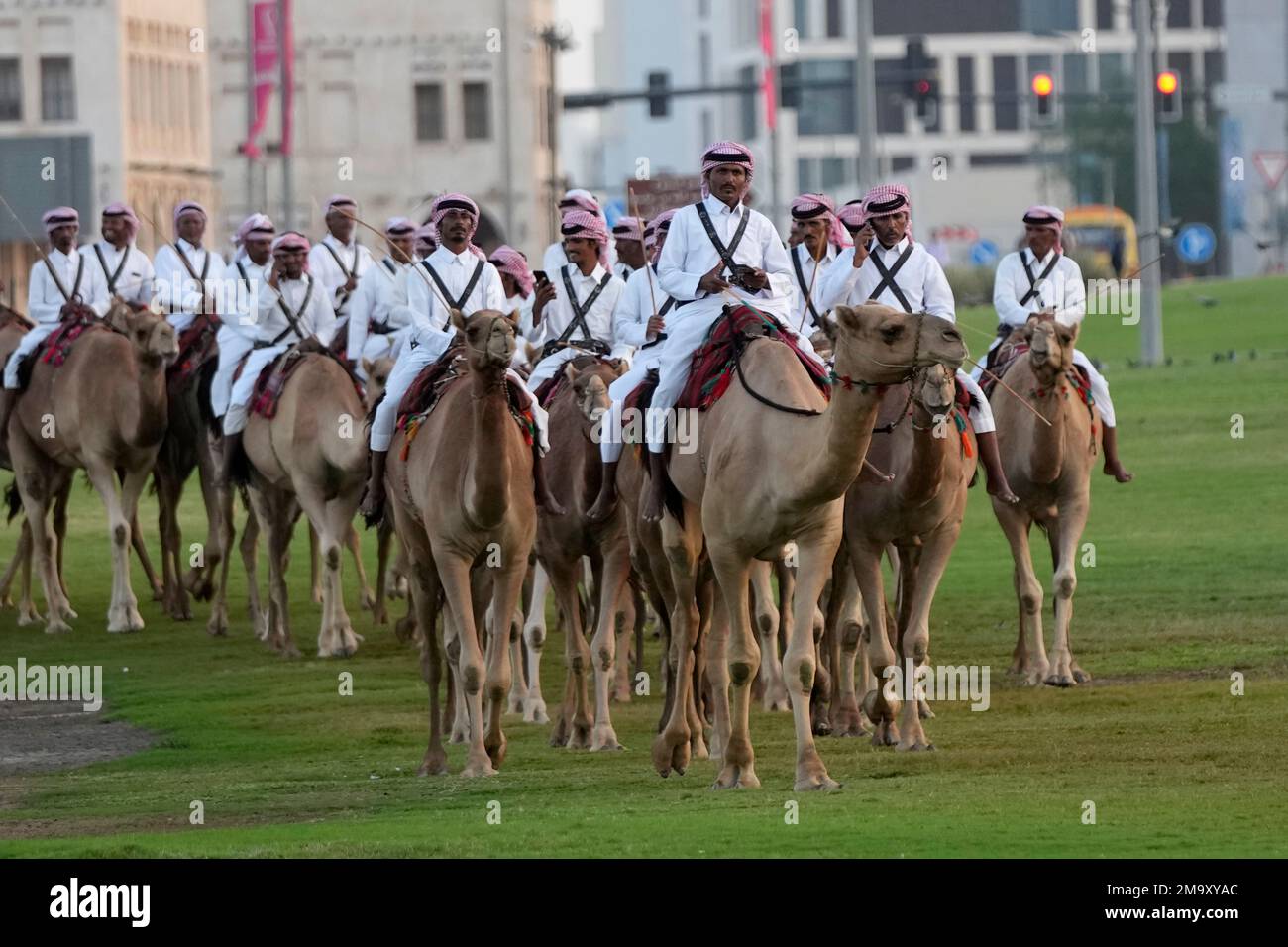 Guards rides their camels outside the Amiri Diwan in Doha, Qatar ...