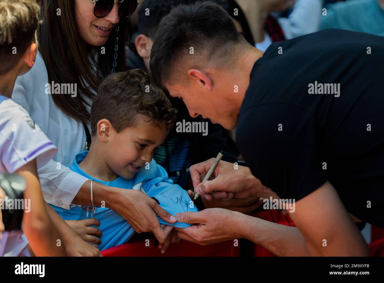 Uruguay's goalkeeper Sergio Rochet autographs a young fan's T-shirt at ...