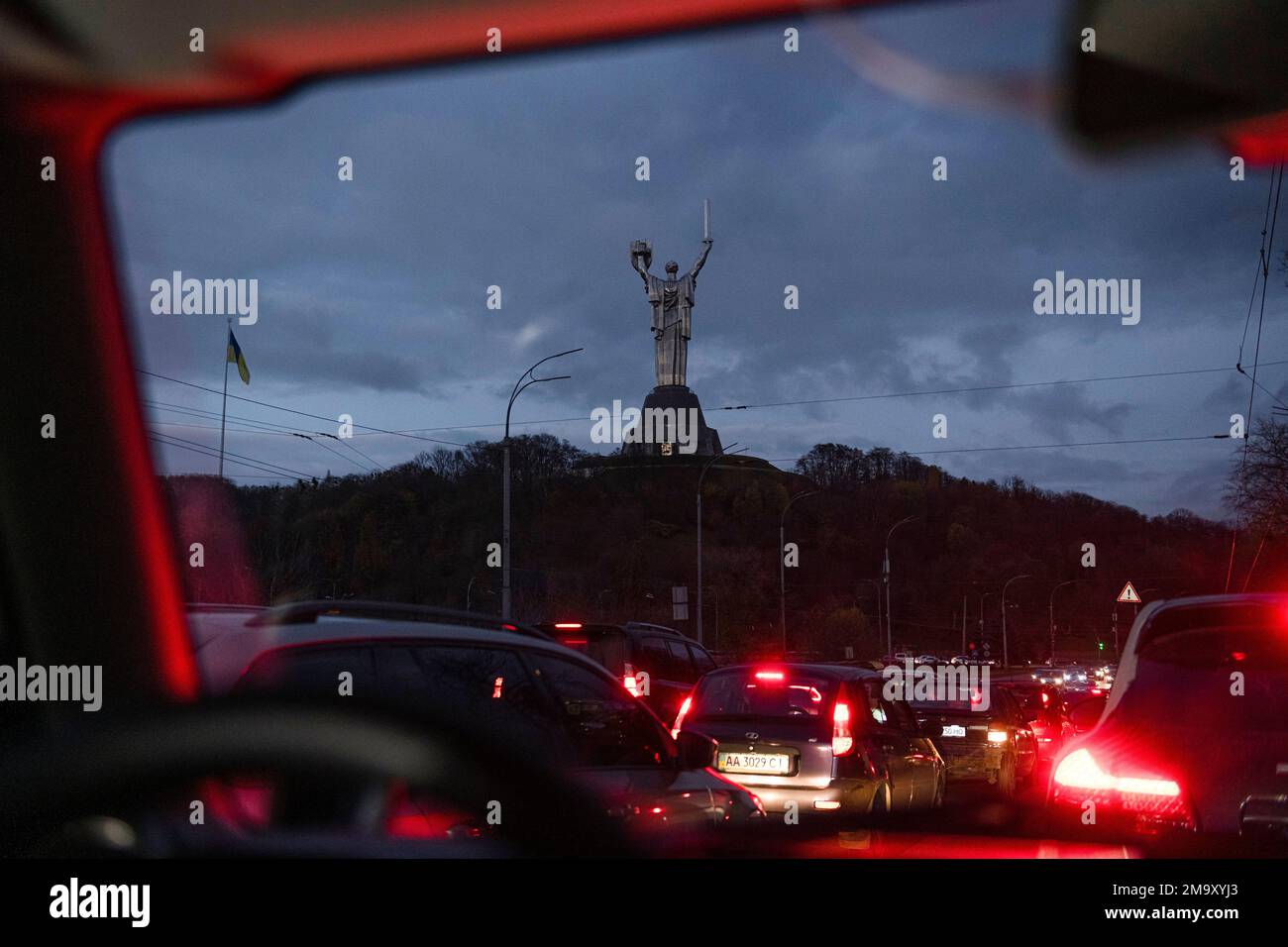 Cars move in the dark, with the Motherland Monument in the background ...