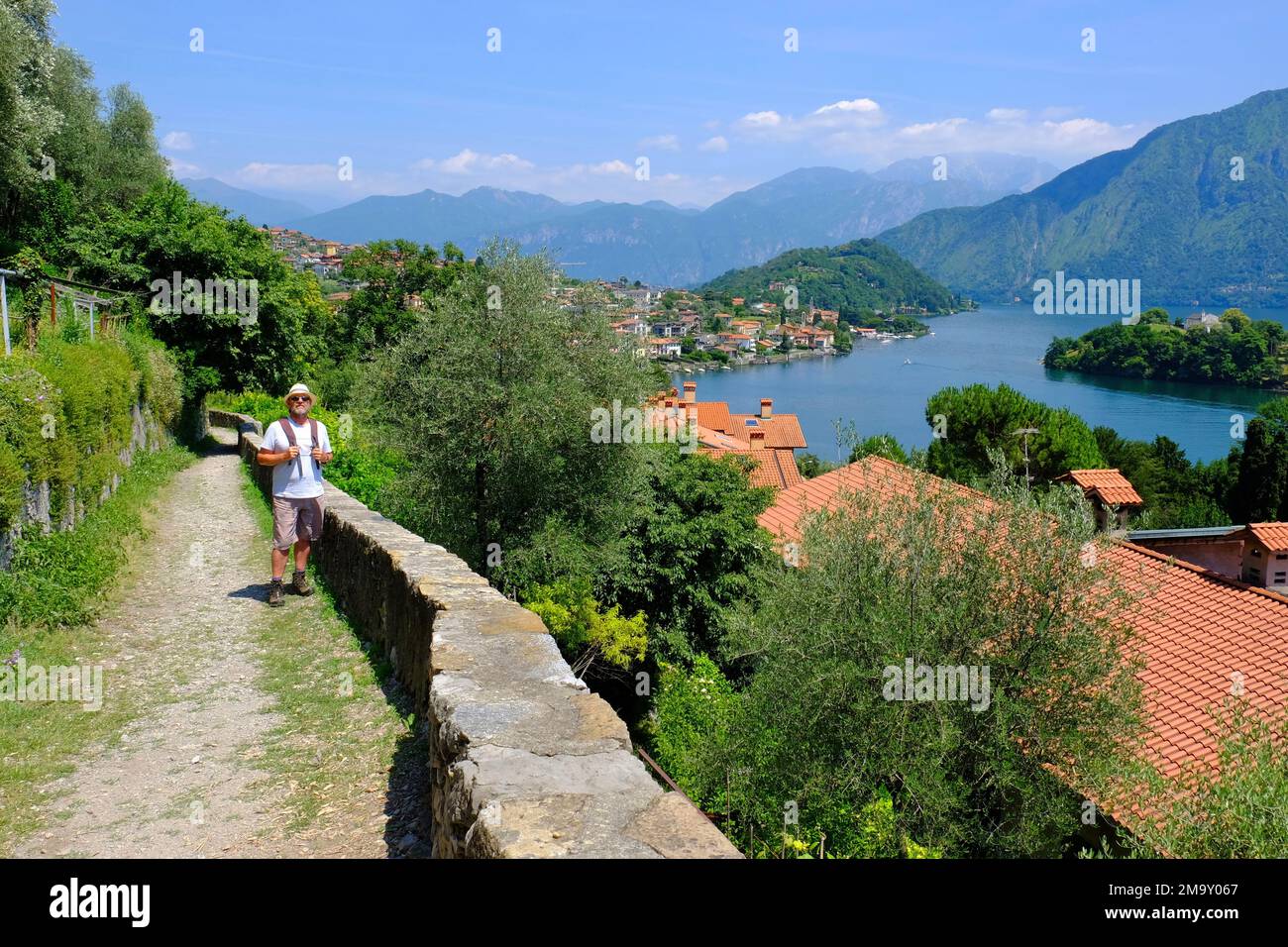 Sala Comacina: Walker on path above Lake Como and Comacina Island at ...