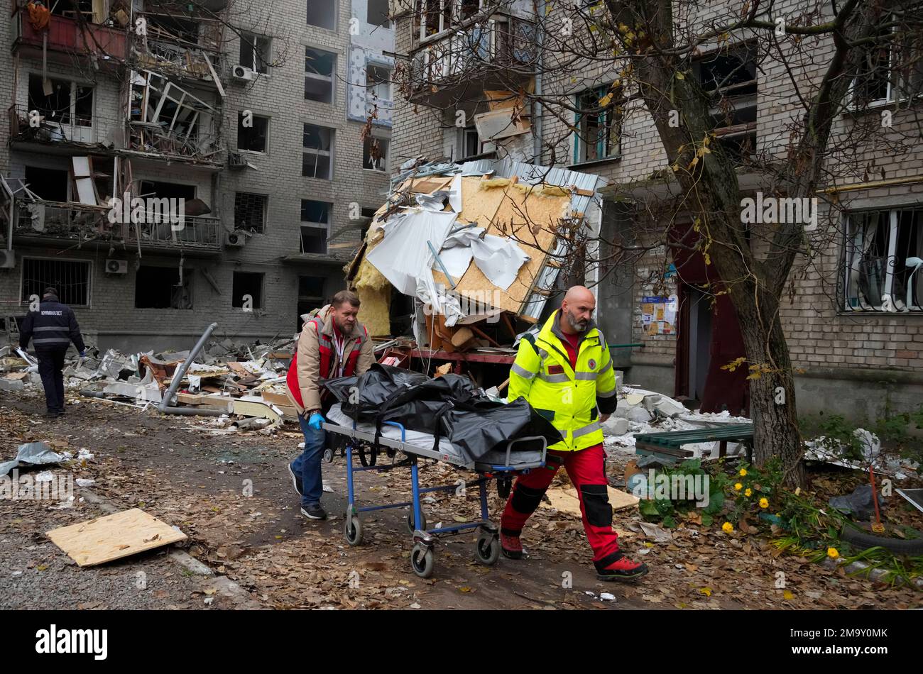 Medics carry the lifeless body of a victim found under rubble at the ...