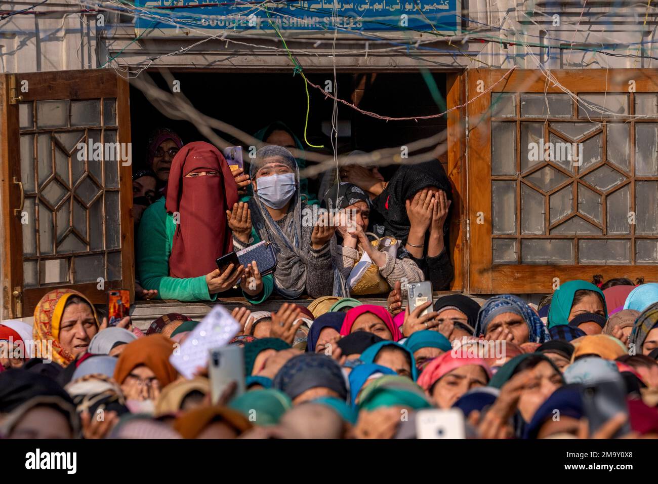 Kashmiri Muslim women devotees pray as a priest displays a relic of ...
