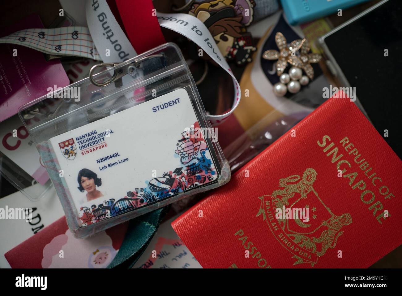 The identity card and Singapore passport belonging to Lune Loh, a 25 ...