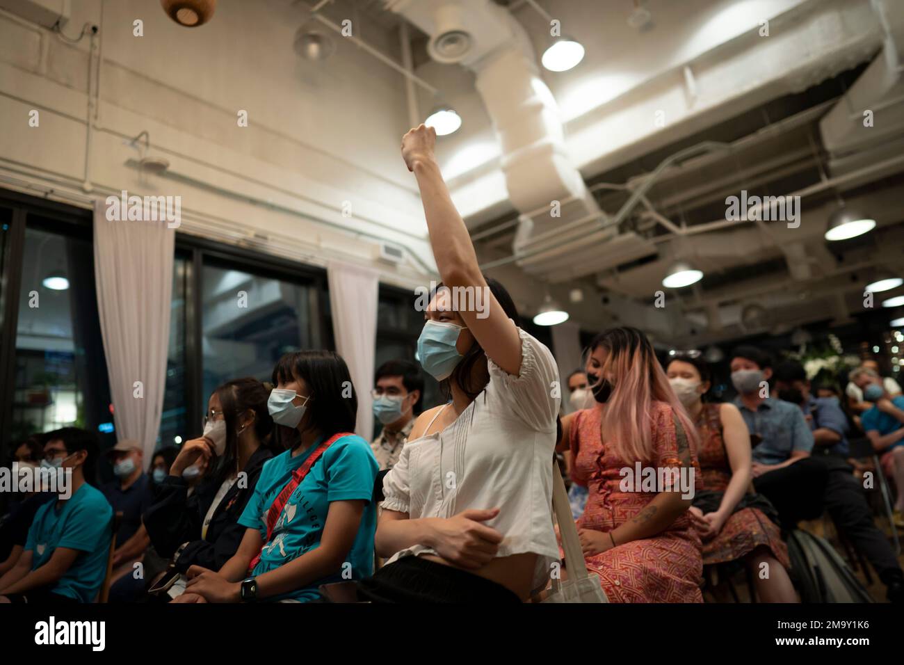 Lune Loh, 25, a transgender woman, snaps her fingers in approval during ...
