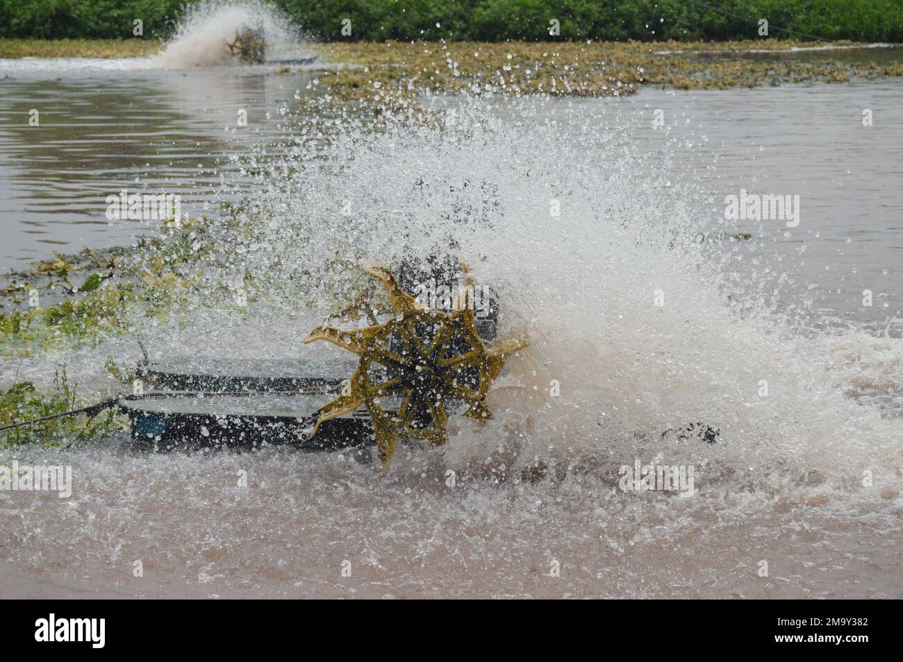 The waterwheel stirs the surface of the water in a sewage treatment ...