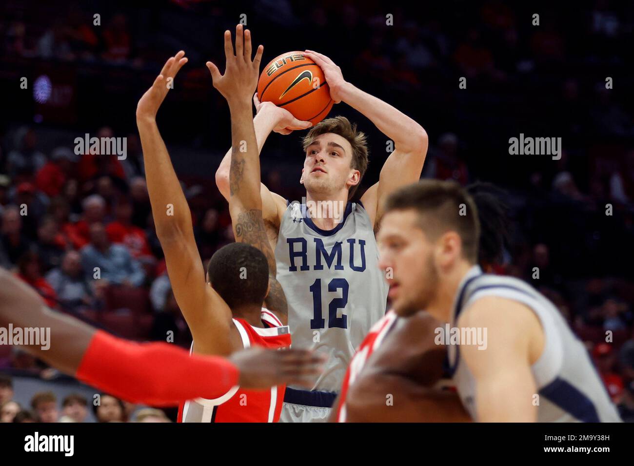 Robert Morris guard Jackson Last, right, goes up for a shot over Ohio ...