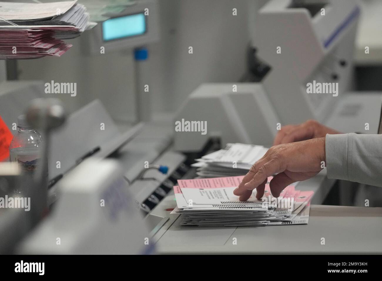 An election worker processes ballots at the Clark County Election ...