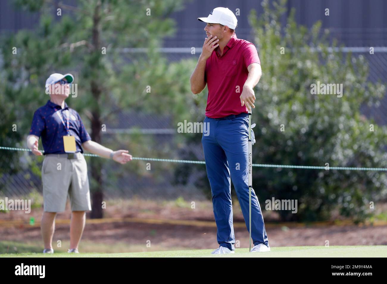 Aaron Wise, right, rubs his chin as he reacts, along with a marshal ...