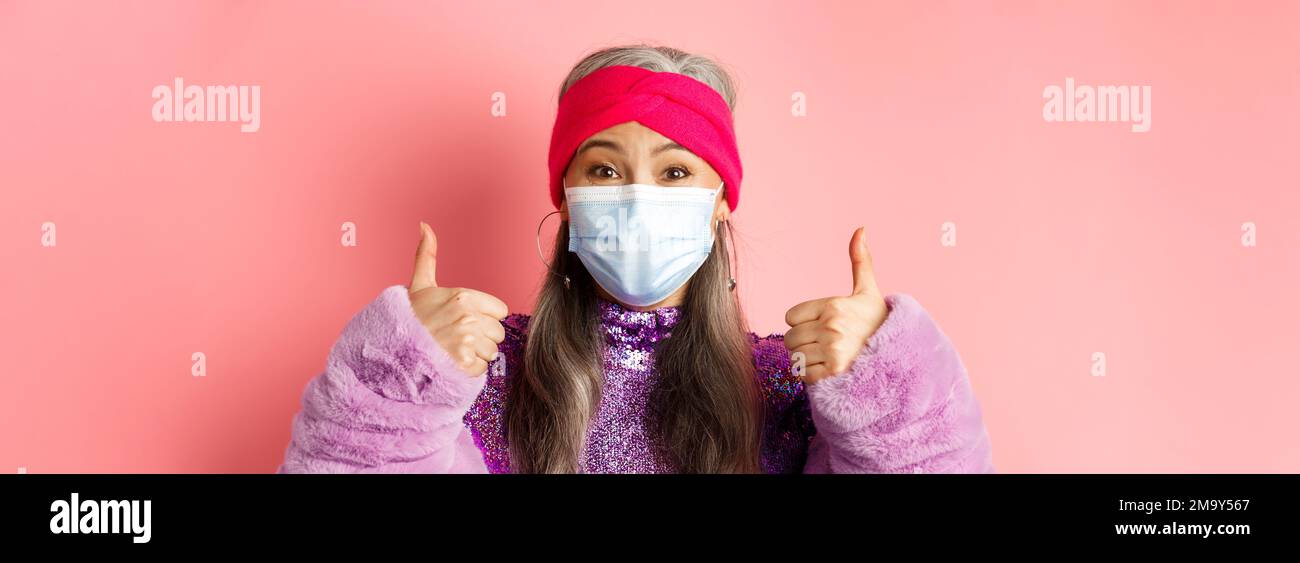 Covid-19, virus and fashion concept. Close-up of fashionable asian ...