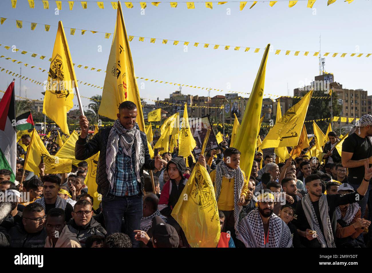 Palestinians chant slogans and wave yellow Fatah movement flags during ...
