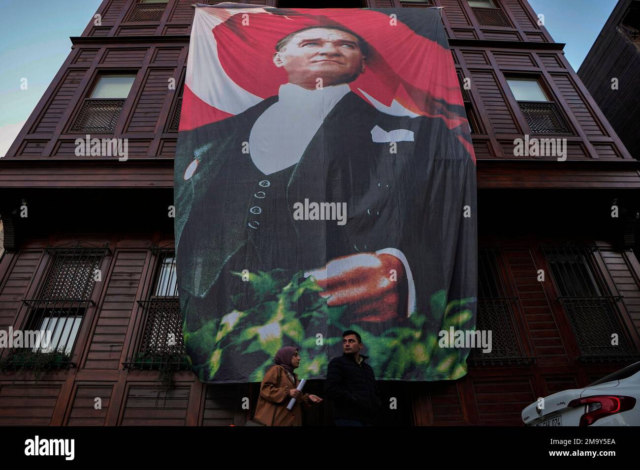 People walk past a picture of Turkey's founding father Mustafa Kemal ...