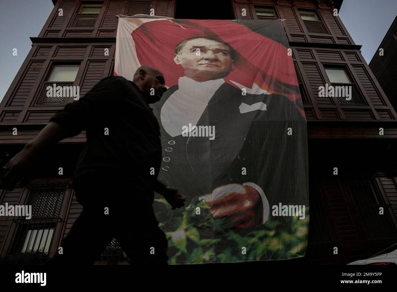 A man walks past a picture of Turkey's founding father Mustafa Kemal ...