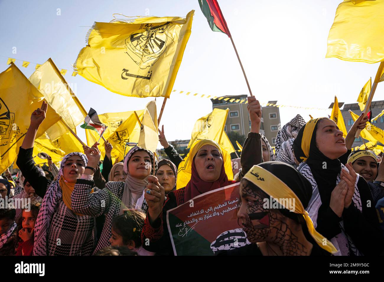 Palestinians chant slogans and wave yellow Fatah movement flags during ...