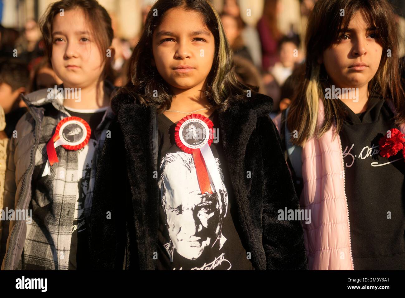 Young girls observe a minute of silence to mark the 84th anniversary of ...
