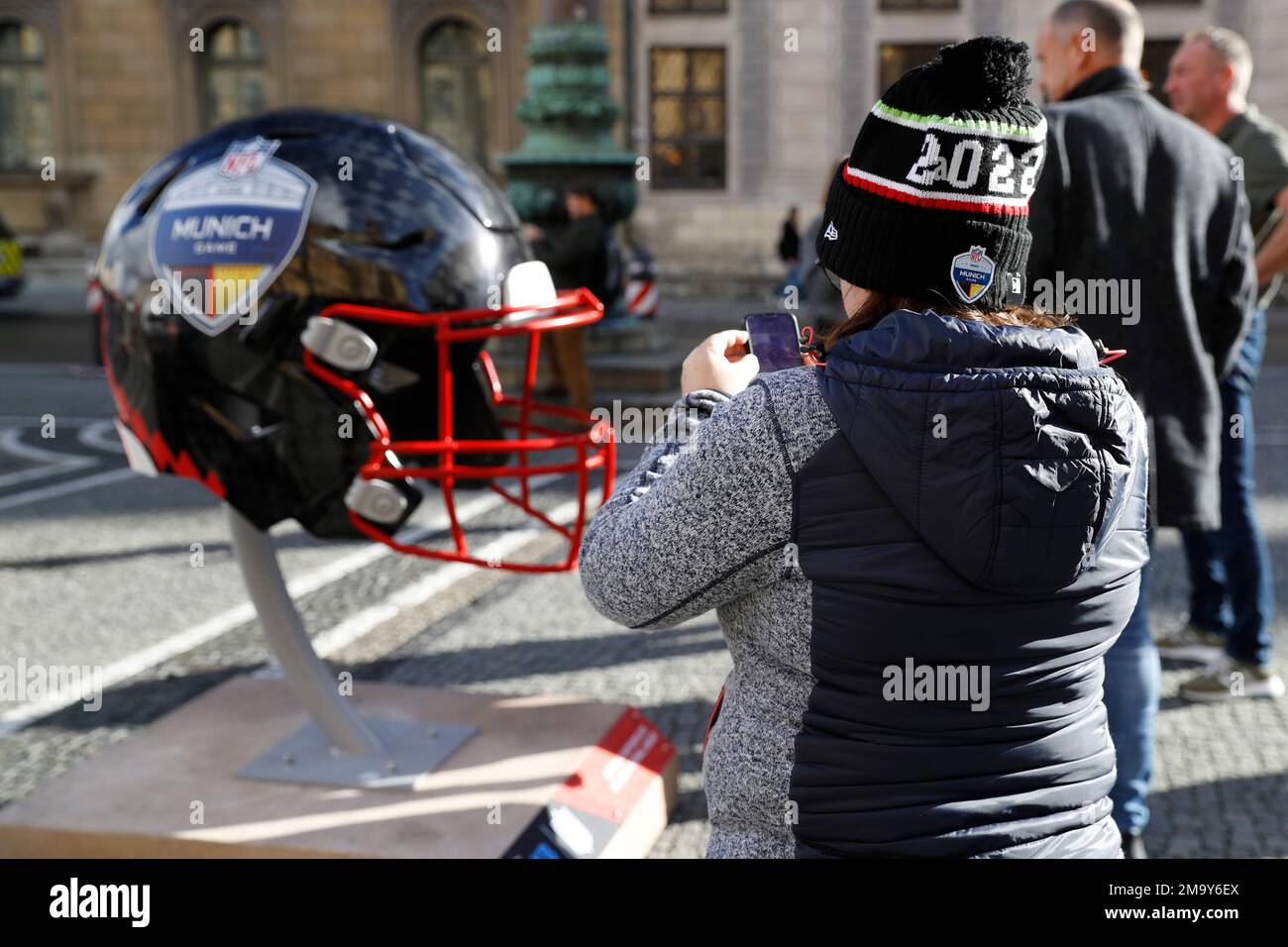 A fan takes a photo of a large NFL helmet at an NFL fan activation at ...