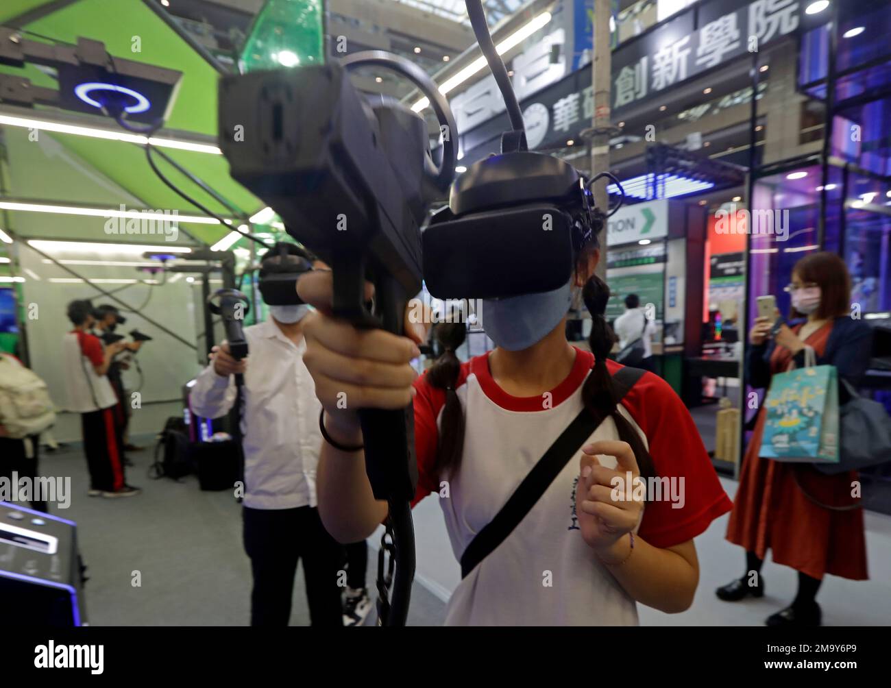 A girl tries a VR set to play VAR BOX game during the IT Month exhibition at the World Trade ...