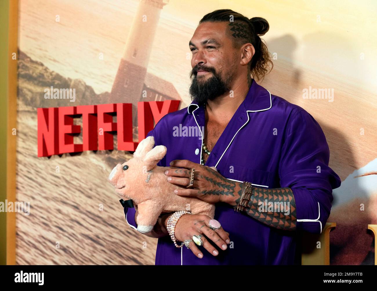 Jason Momoa, star of "Slumberland," poses with a stuffed pig featured ...
