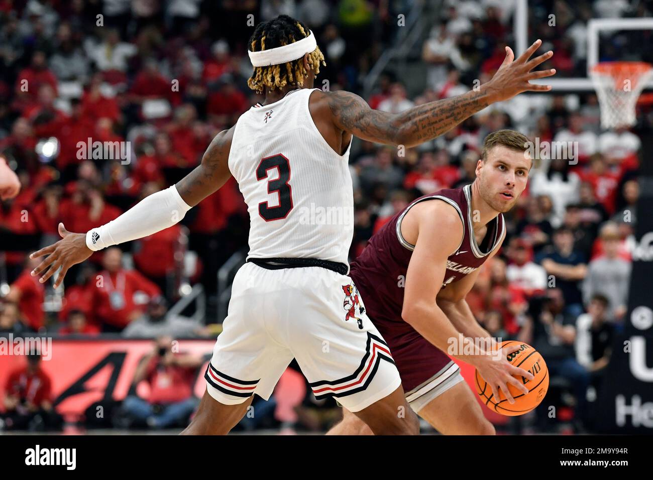 Bellarmine guard Garrett Tipton (10) looks for help as Louisville guard ...
