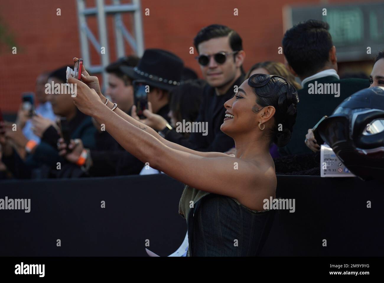Mabel Cadena takes a selfie with fans on the red carpet at the premiere ...
