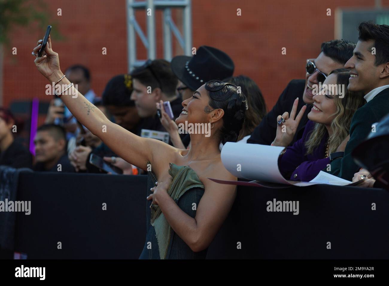 Mabel Cadena takes a selfie with fans on the red carpet at the premiere ...