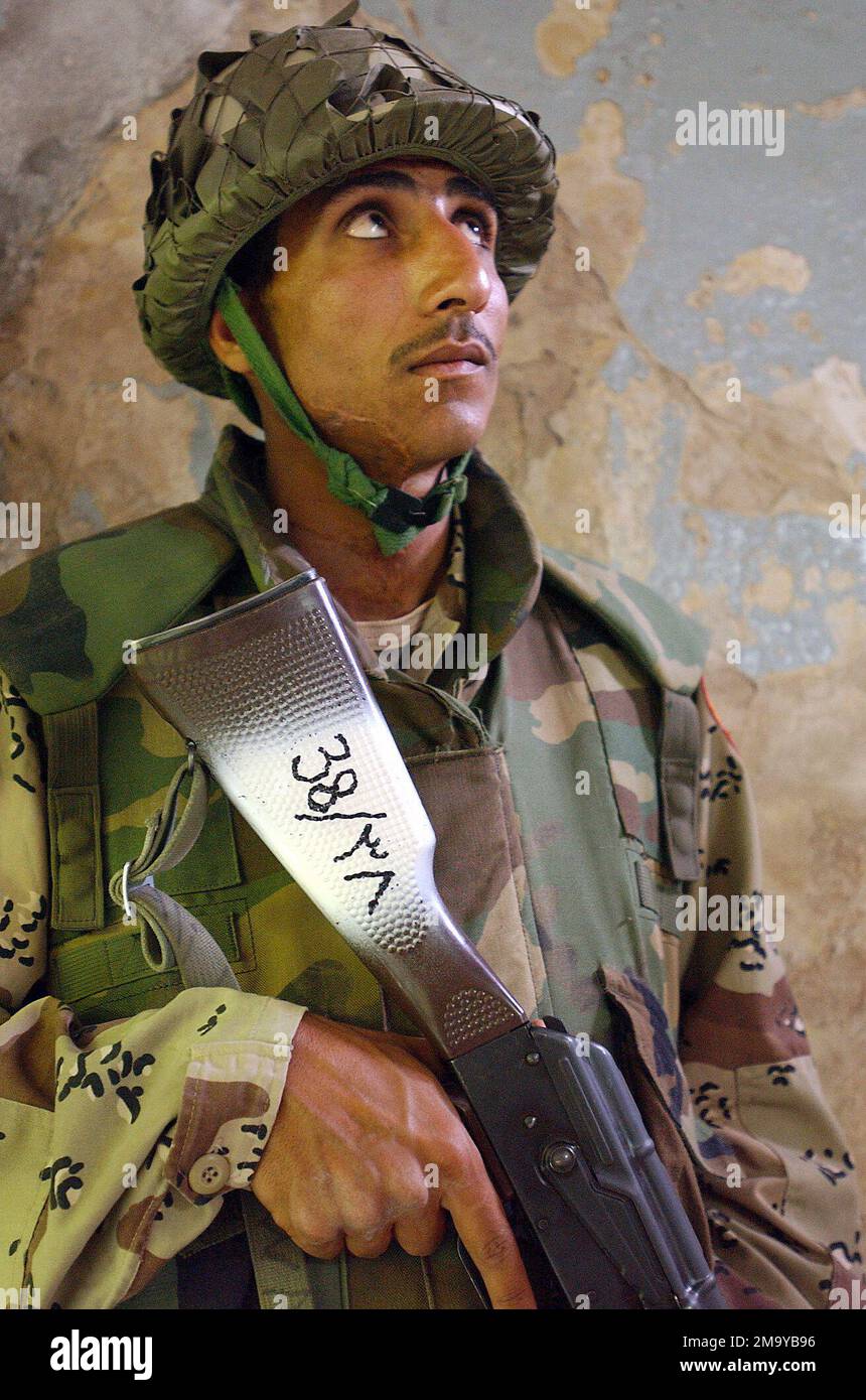 A member of the Iraqi Civil Defense Corp (ICDC) backs his team members ...