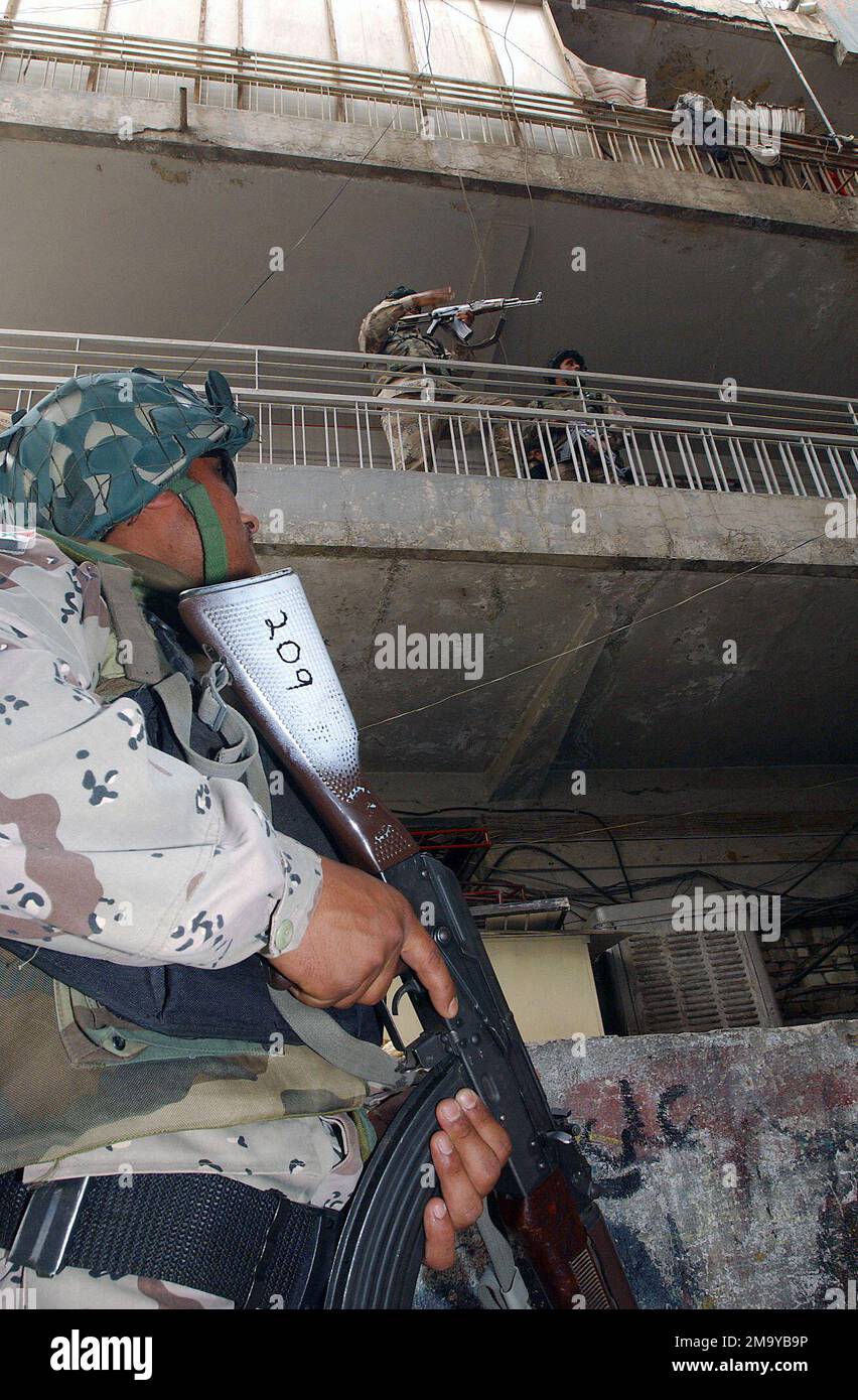 A member of the Iraqi Civil Defense Corp (ICDC) backs his team members ...