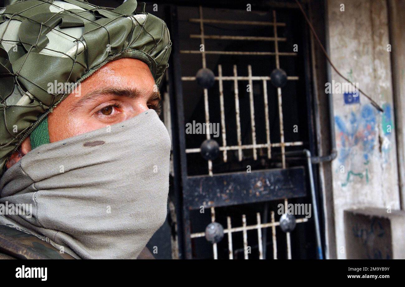 A member of the Iraqi Civil Defense Corp (ICDC) keeps watch outside an ...
