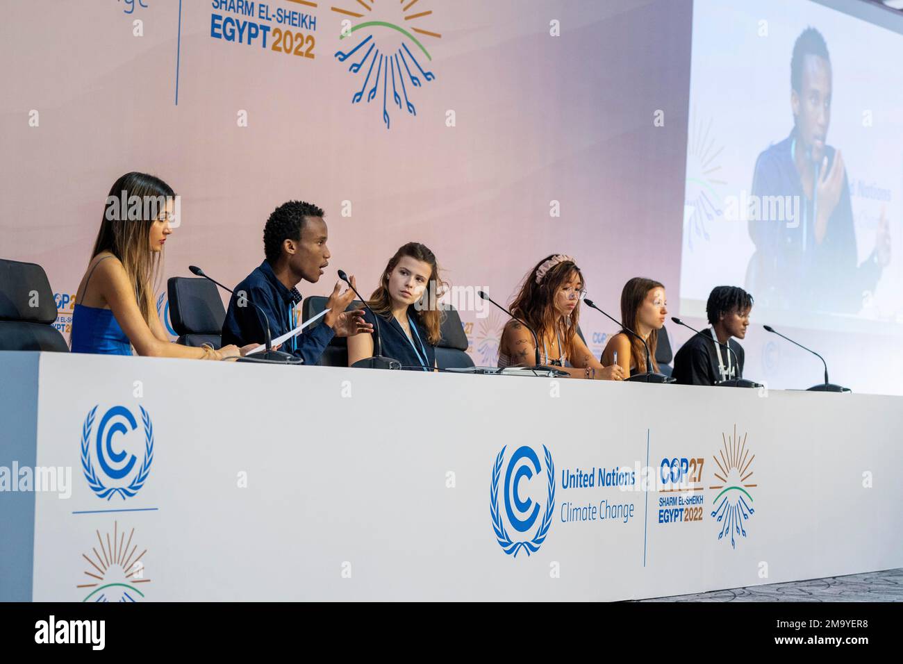 Eric Njuguna, of Kenya, second from left, speaks with other youth ...