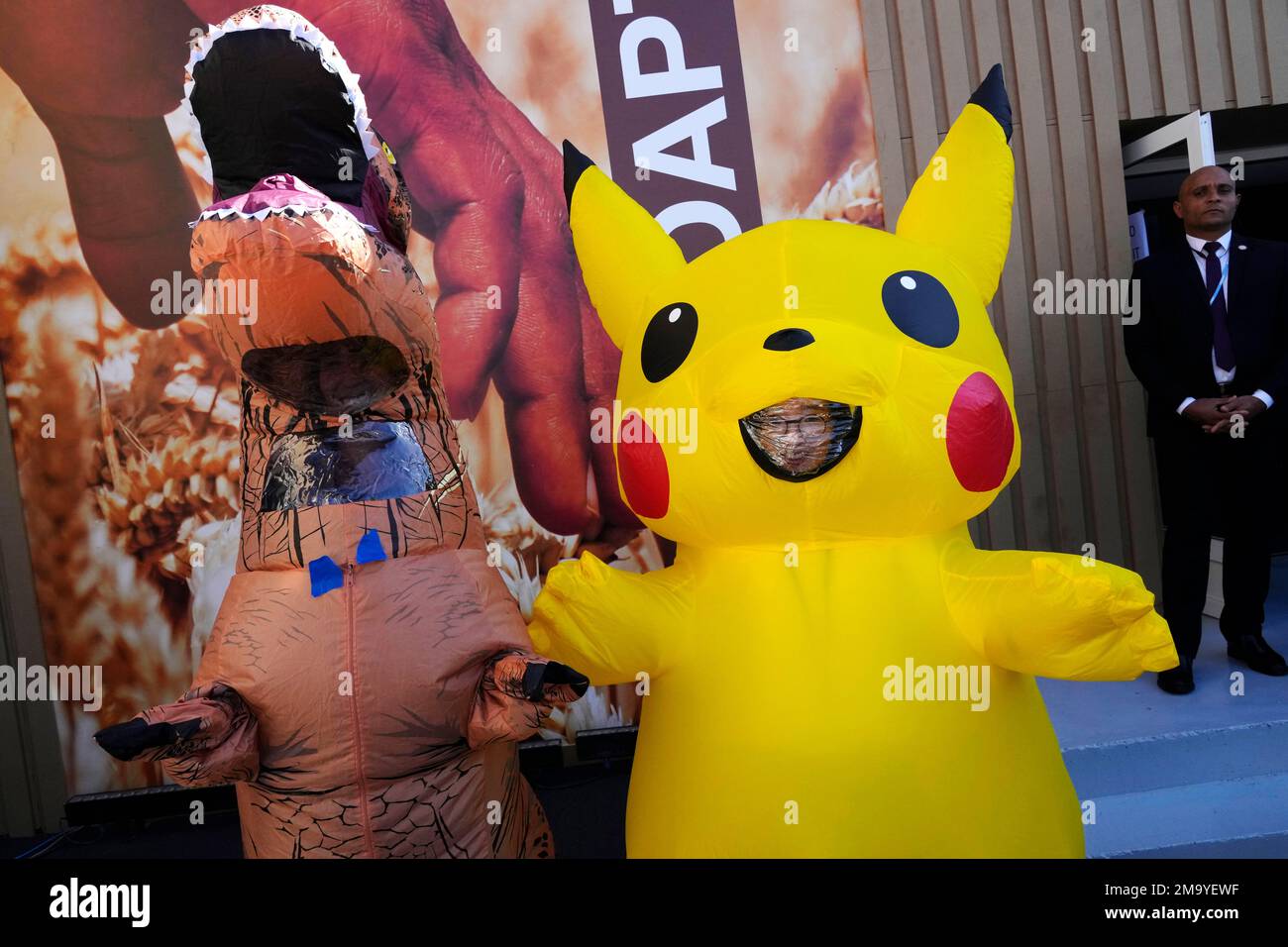 Demonstrators dressed up in a dinosaur and Pikachu participate in an ...