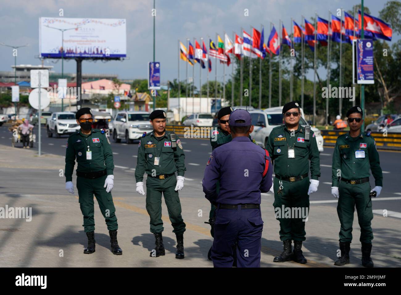 Police officers pose for a souvenir in a group photo as they guard near ...