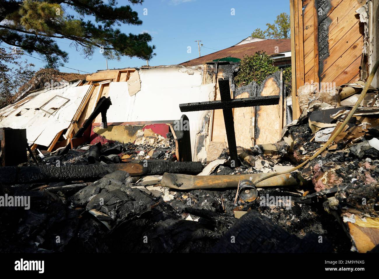 Melted siding, burned insulation, charred wooden beams and ashes of old ...