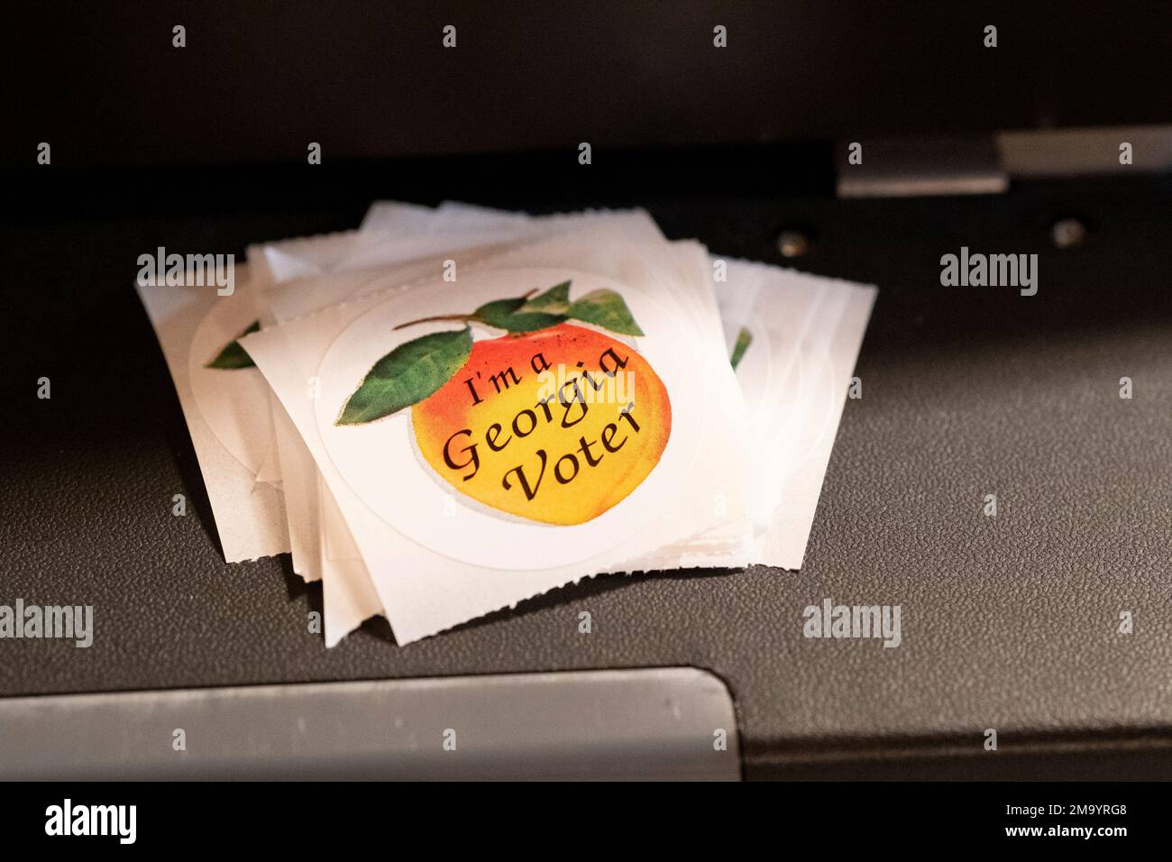 A stack of stickers sits atop the ballot scanner during the mid-term ...