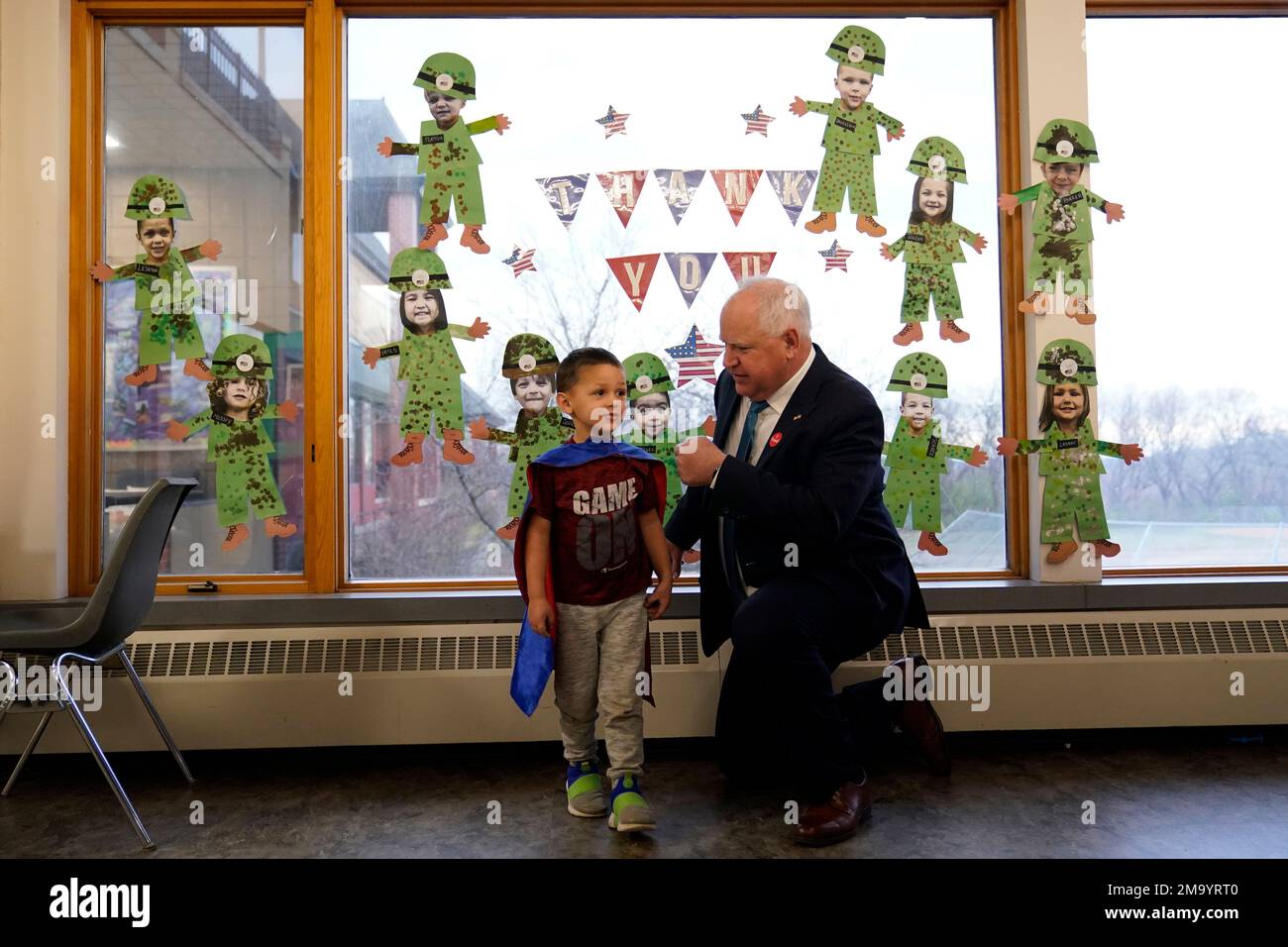 Minnesota Gov. Tim Walz, right, fist-bumps with Binny, 4, after voting ...