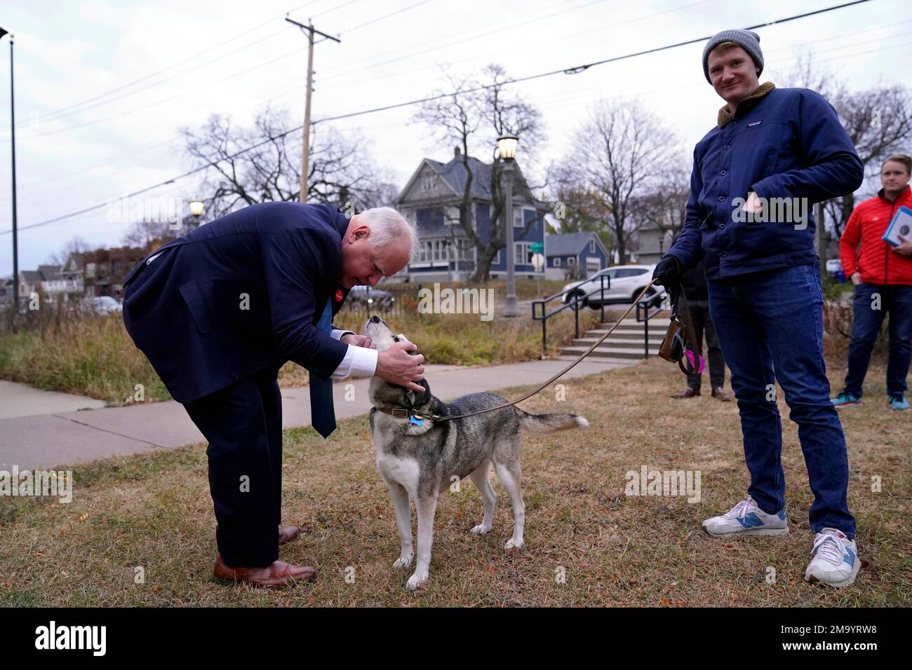Minnesota Gov. Tim Walz, left, pets a Siberian Husky after voting ...