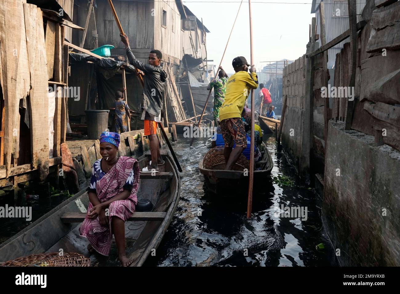 People travel by canoe in the floating slum of Makoko in Lagos, Nigeria ...