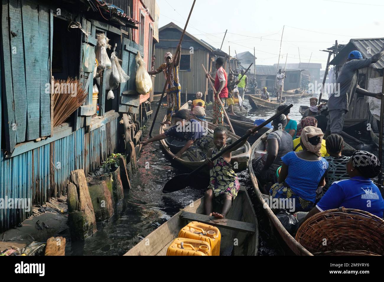People travel by canoe in the floating slum of Makoko in Lagos, Nigeria ...