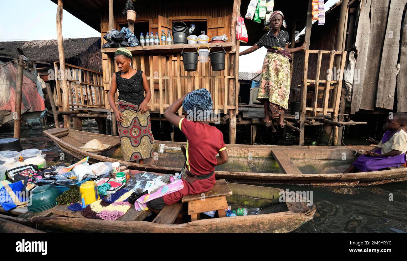 A woman shops for clothes at the floating slum of Makoko in Lagos ...