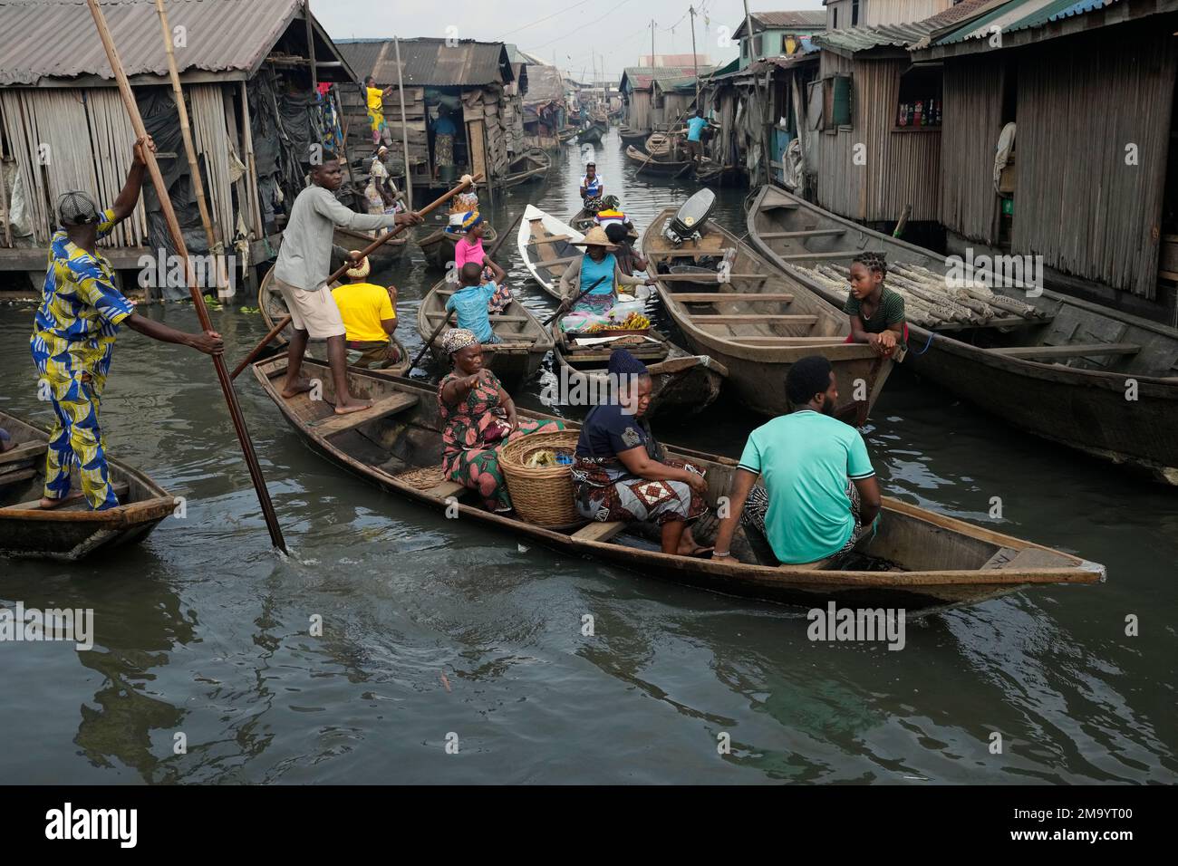 People travel by canoe in the floating slum of Makoko in Lagos, Nigeria ...