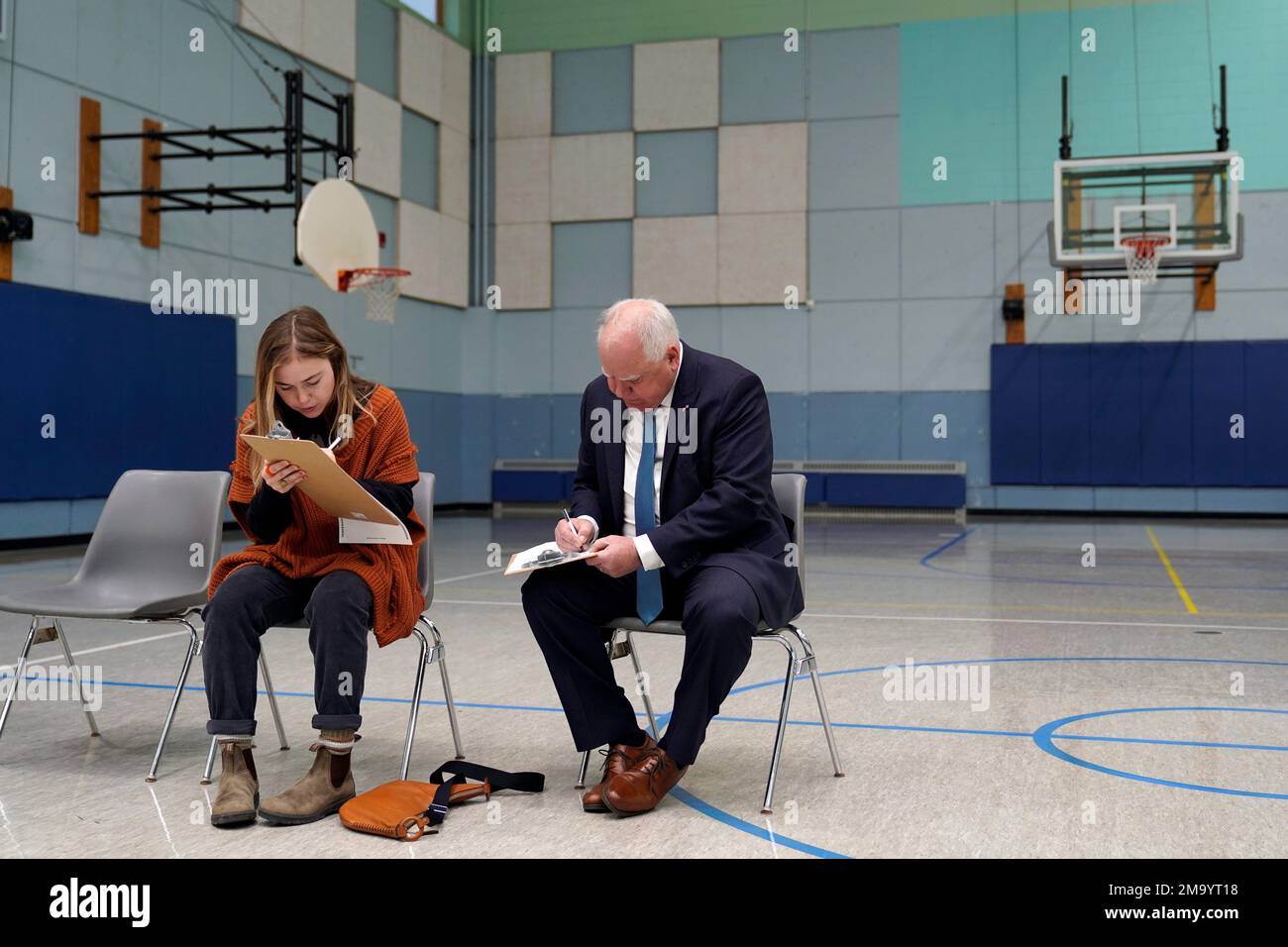 Minnesota Gov. Tim Walz, right, and his daughter, Hope, fill out their ...