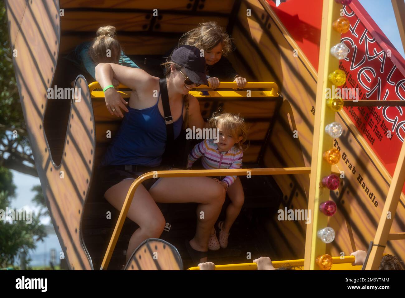 Allison Fuller, a Status of Forces Agreement Personnel rides a carnival ...