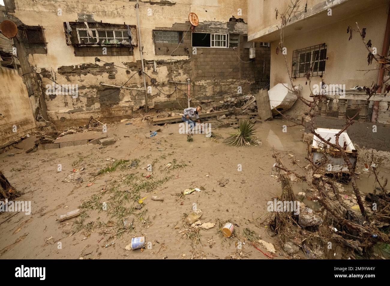 Wesam AL Shawa inspects destroyed wall at the yard of the flooded ...