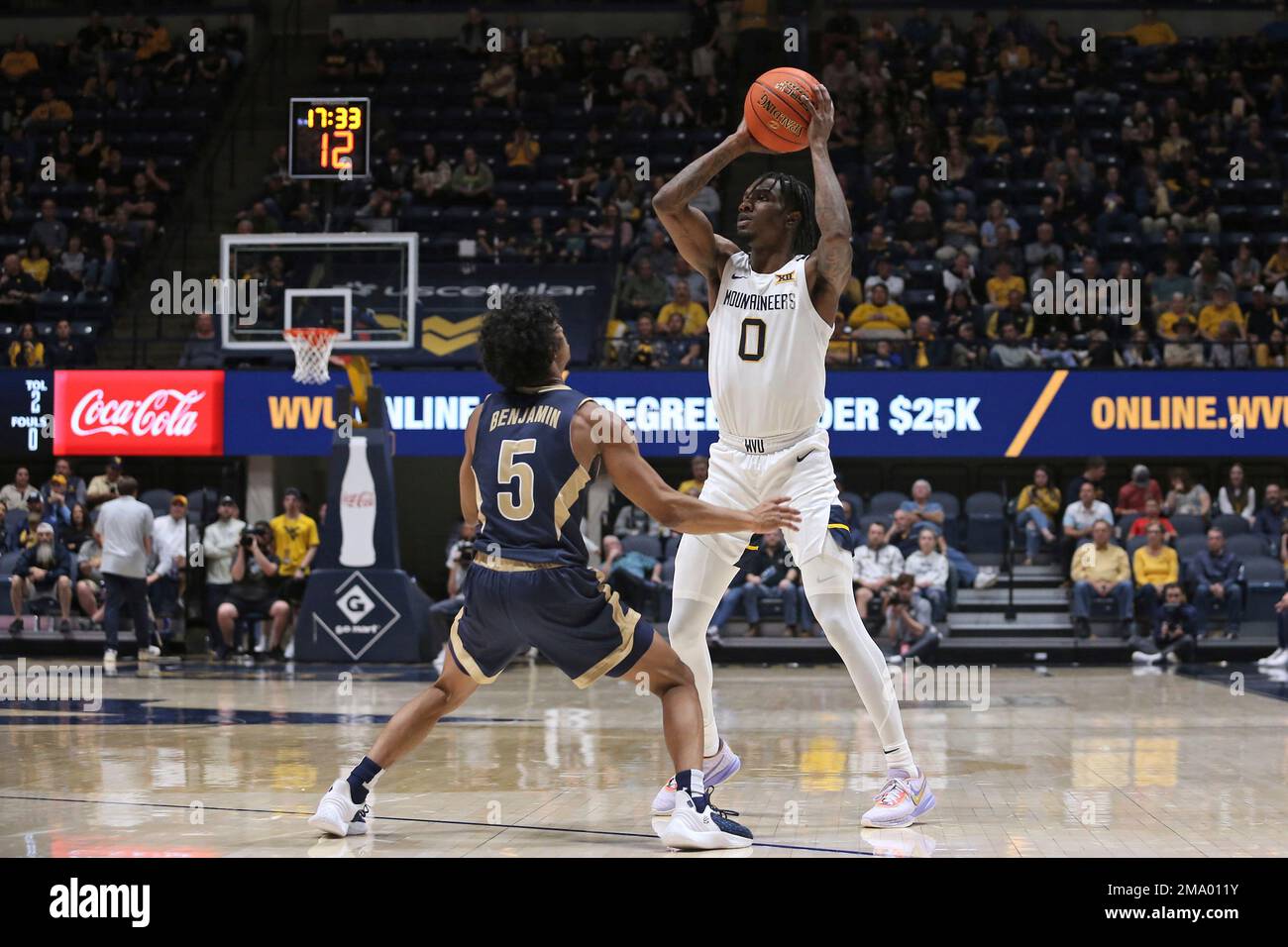 West Virginia guard Kedrian Johnson (0) is defended by Mount St. Mary's ...