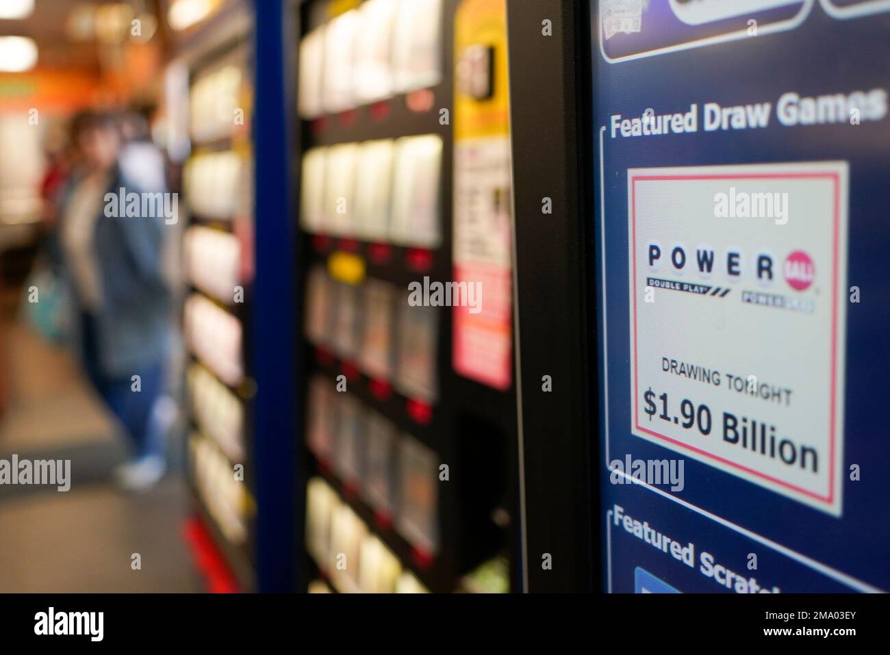A woman enters a convenience store near a vending machine that sells ...