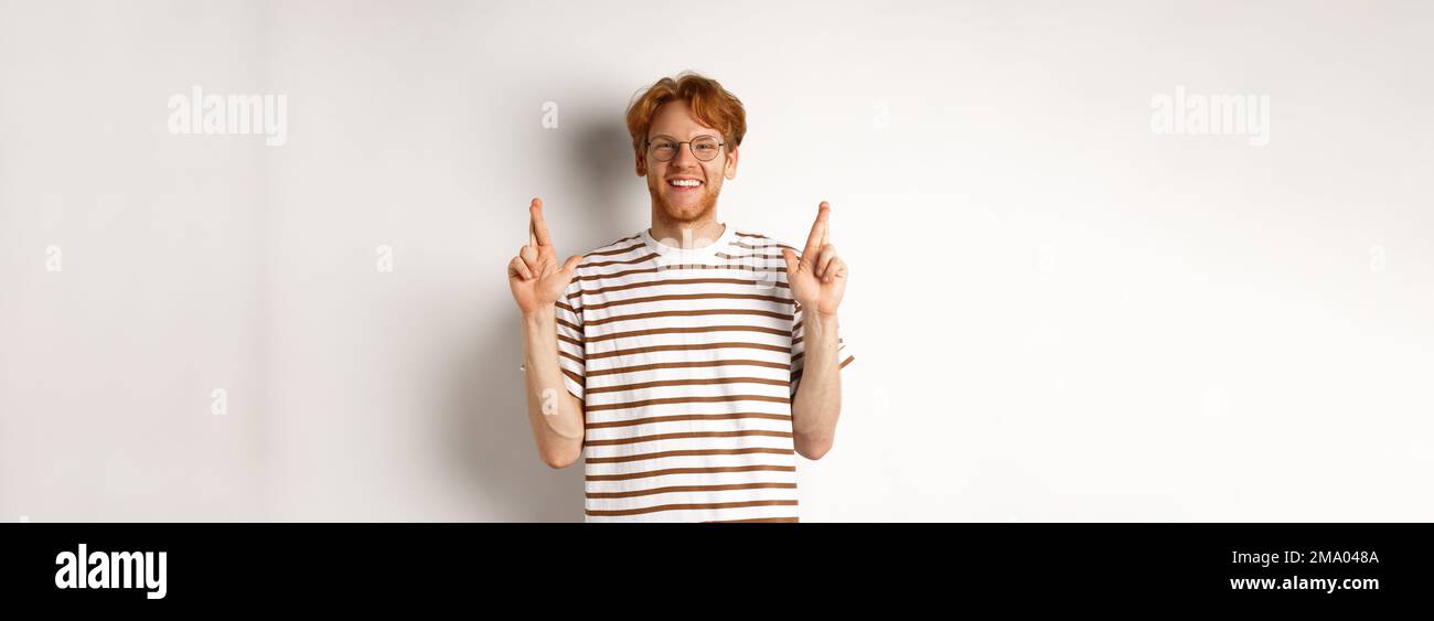 Hopeful and optimistic man with ginger hair and glasses having hope ...