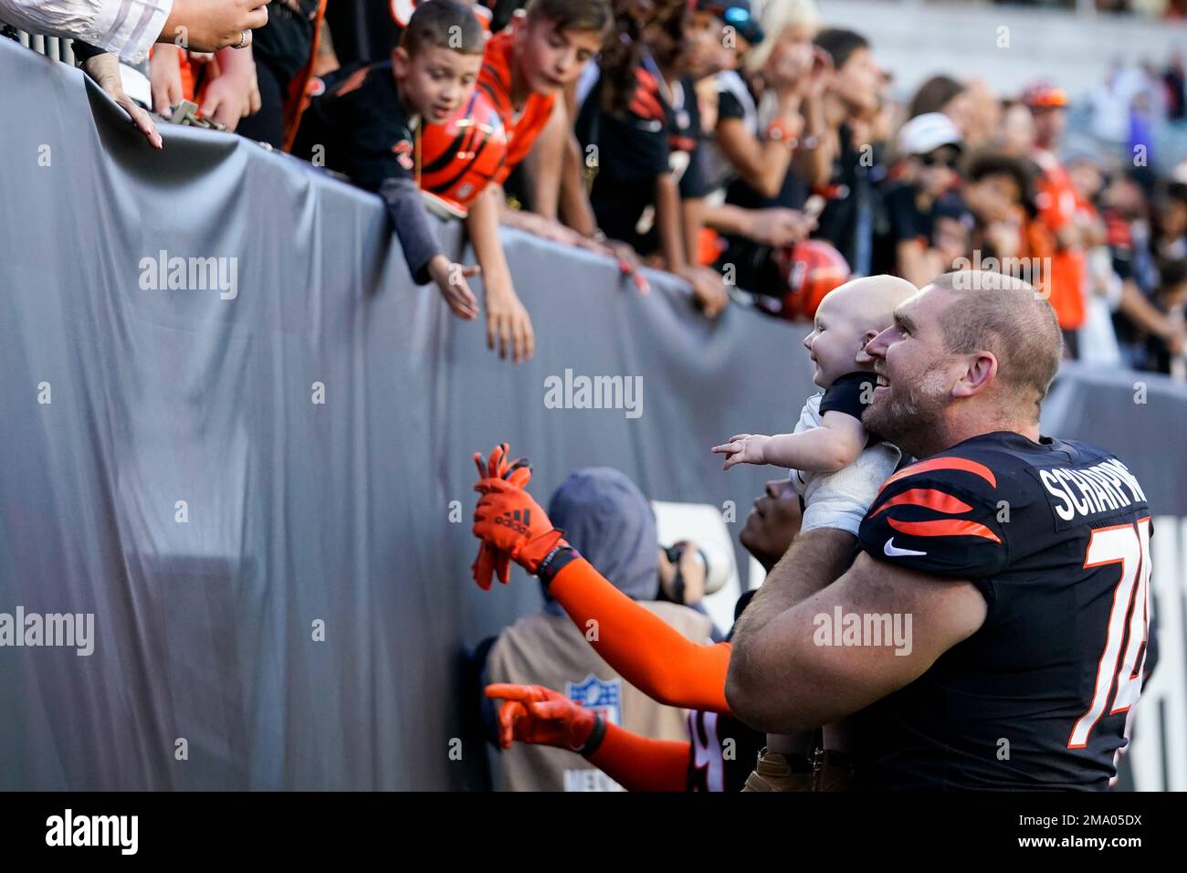 Cincinnati Bengals guard Max Scharping (74) holds a child following an ...
