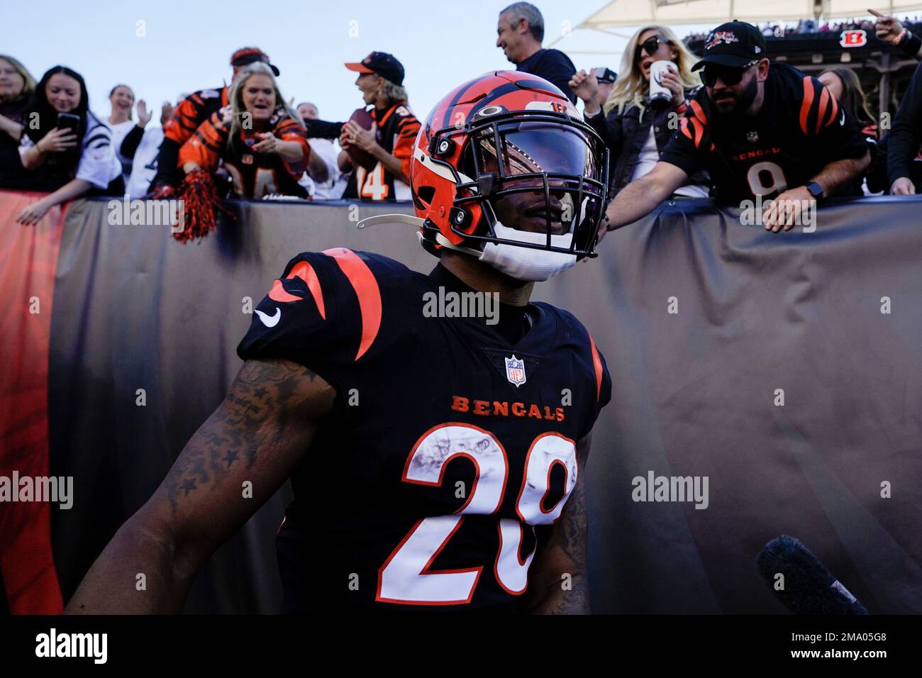 Cincinnati Bengals running back Joe Mixon (28) gives a fan a football ...