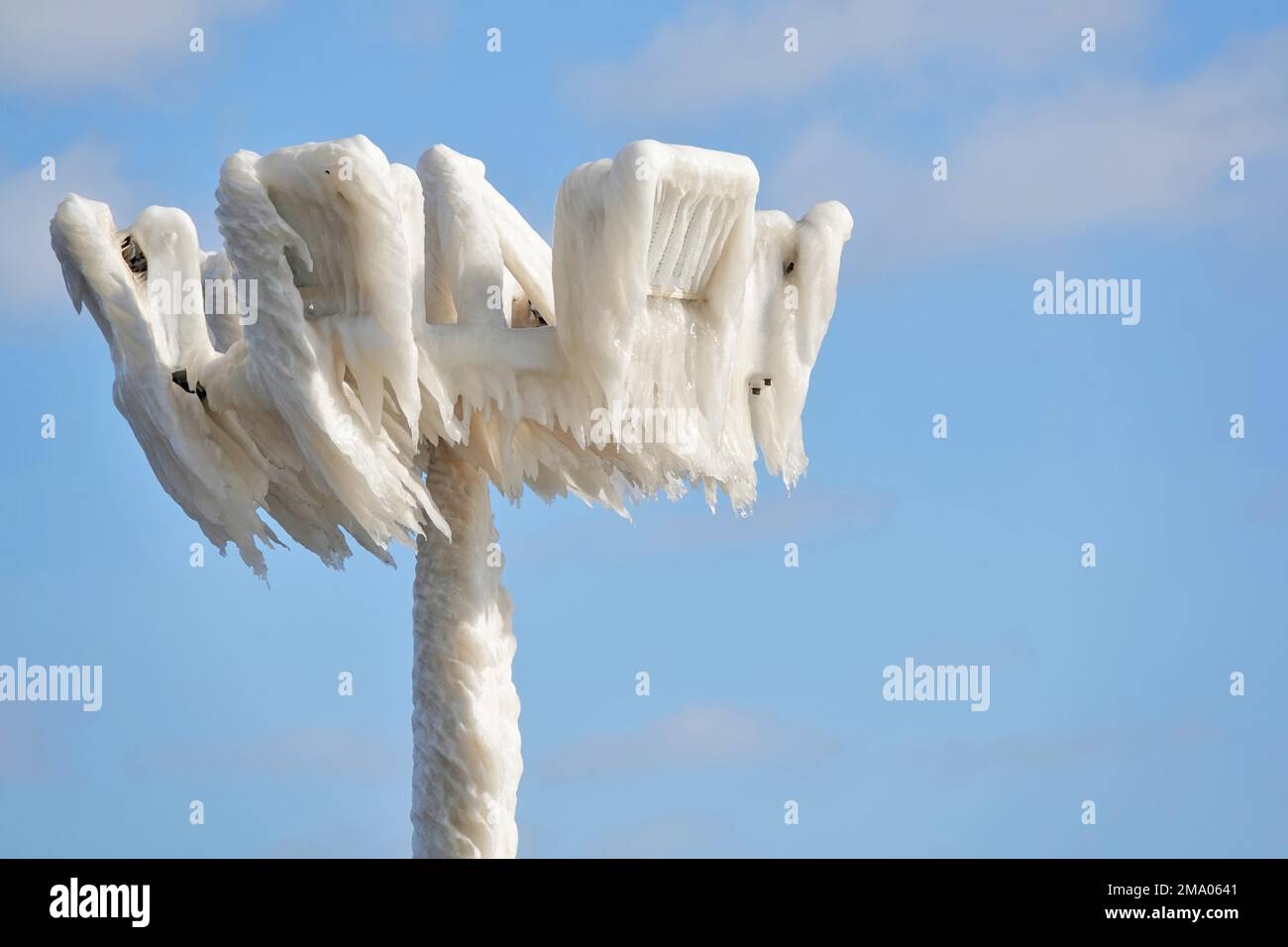 Icicles hang from iron chains at the coast in the cold winter, looking ...