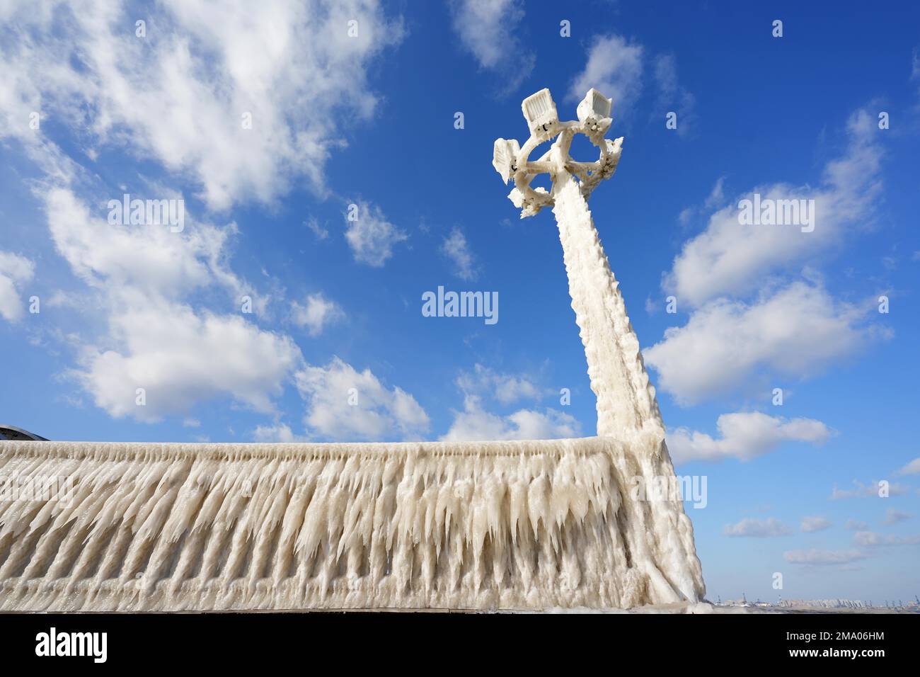 Icicles hang from iron chains at the coast in the cold winter, looking ...