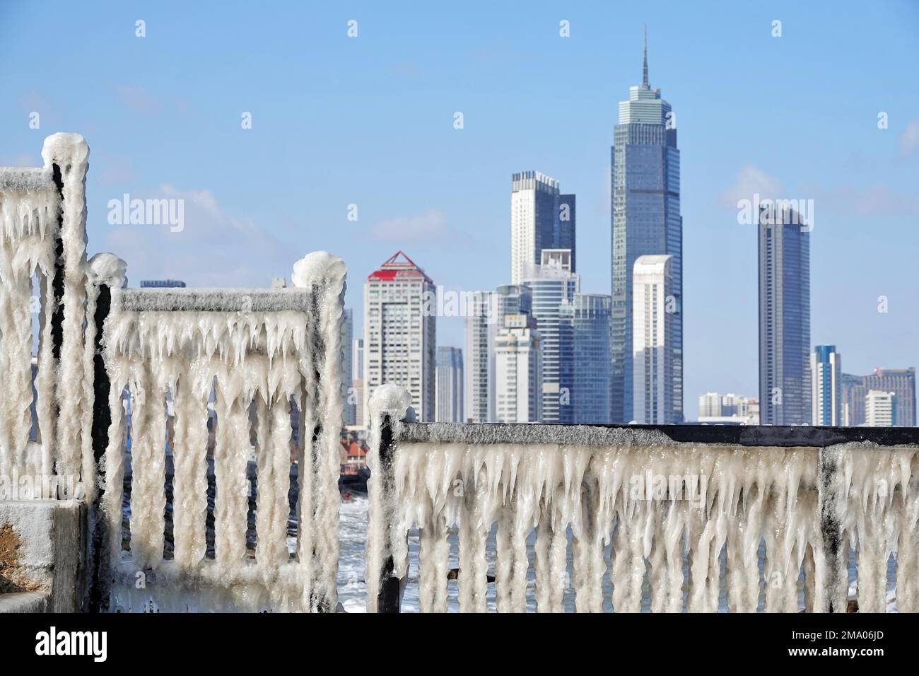 Icicles hang from iron chains at the coast in the cold winter, looking ...